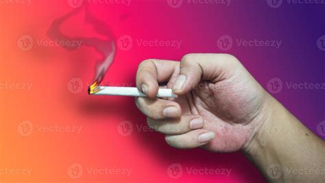 Hands Hold The Cigarette With Smoke In Isolate Color Background