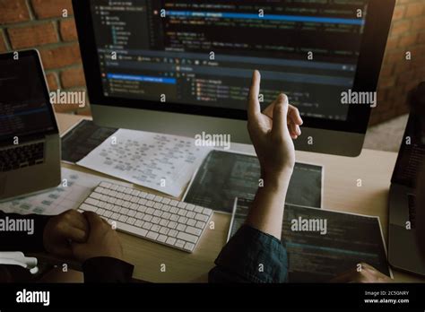 Two Software Developers Are Analyzing Together About The Code Written Into The Program On The