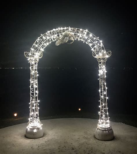 Arch Wrapped In Twinkly Lights Looking North To The View Of Lights On