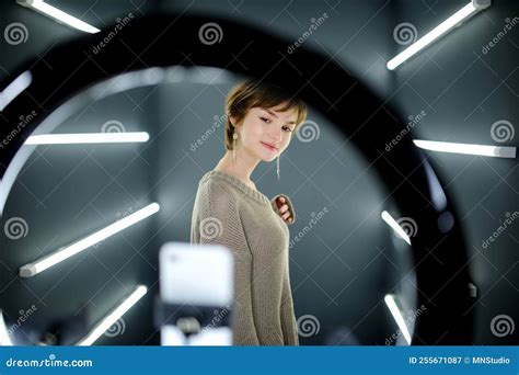Beautiful Teenage Girl Taking A Selfie Picture With Mobile Phone In Light Of The Ring Lamp Stock