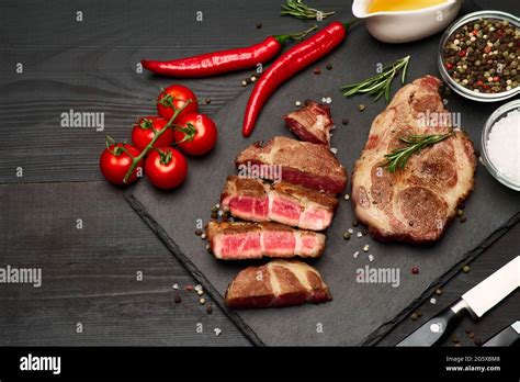 Grilled Sliced Roated Beef Steaks On Stone Serving Cutting Board Stock