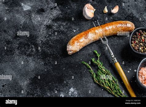 Pork Sausage Bbg Grilled With Spices And Herbs On A Meat Fork Top View Black Background Copy