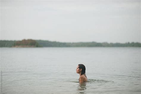 Girl Swimming In Lake By Stocksy Contributor Michelle Edmonds Stocksy