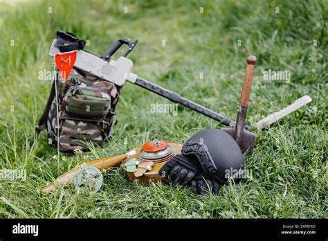 Explosive Devices And A Metal Detector Lie On The Background Of A
