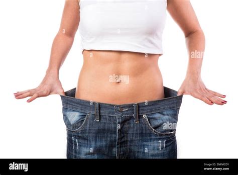 A Fit Girl Stretching Her Jeans Demonstrating A Large Gap Around Her