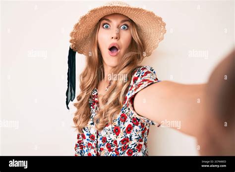 Young Caucasian Woman With Blond Hair Wearing Summer Hat Taking A