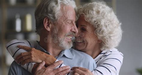 Cheerful Old Couple Hugging Laughing Bonding Looking At Camera Stock