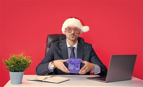 Mature Man Wear Santa Claus Hat And Party Glasses Hold Present Box