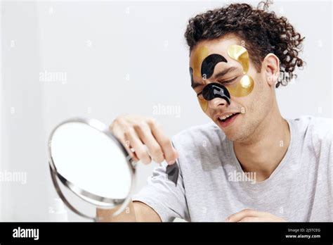 Guy With Curly Hair In A White T Shirt With Patches On The Face Rejuvenation Skin Care Stock