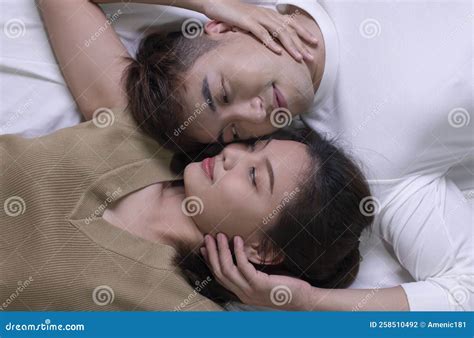 Asian Couples Lie On The Bed Faces Close To Each Other In Love High