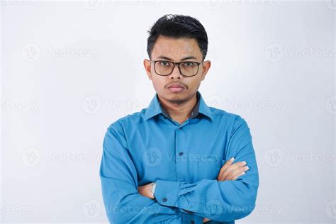 Angry Asian Man With Glasses Standing With Crossed Arms And Looking At