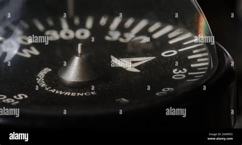Close Up Of A Glass Domed Oil Filled Ships Compass Showing Central