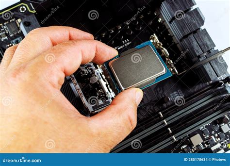 In Process Of Assembling A Desktop Computer Technician Is Plugging Cpu Into Socket On
