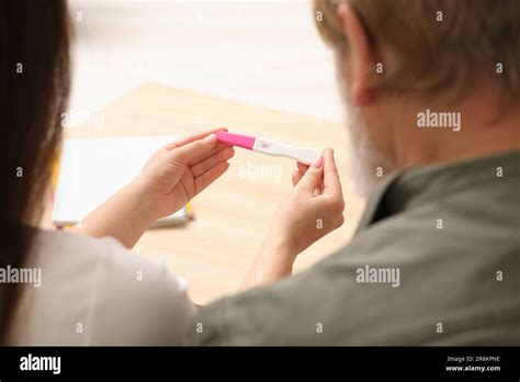 Daughter Showing Her Father Pregnancy Test Indoors Closeup
