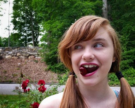 Premium Photo Teenage Girl Eating Cherry At Park