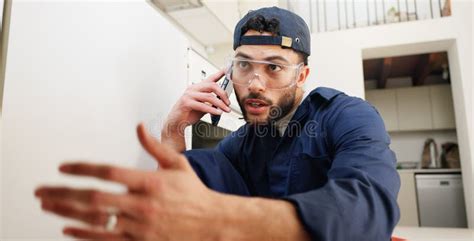 Plumber Worker And Man With Phone Call In Kitchen For Pipeline Problem Leakage Repair And Sink