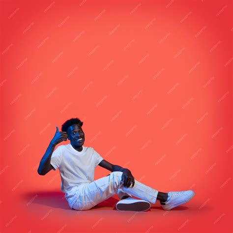 Premium Photo Cool Black Guy Sitting On Floor Showing Thumb Up