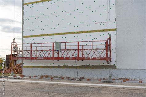 Building Cradle On The Renovated House Wall Facade Insulation With