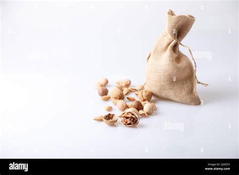 Assorted Nuts In The Shell On A White Background Walnuts Pecans Almonds Macadamia Nuts In A