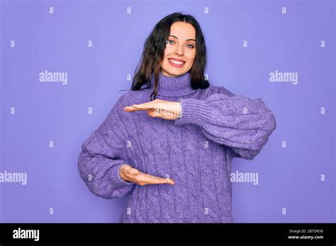 Young Beautiful Woman Wearing Casual Turtleneck Sweater Standing Over